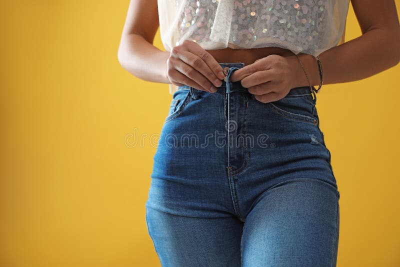 Woman Unbuttoning Jeans on Blue Background Stock Photo - Image of body ...