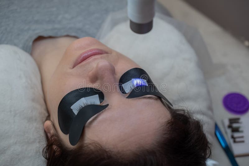 A Woman Undergoing Eyelash Extension Procedure Using an Ultraviolet ...
