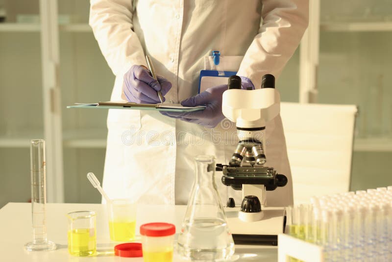 Woman in Uniform Makes Notes after Doing Urine Sample Test Stock Photo ...