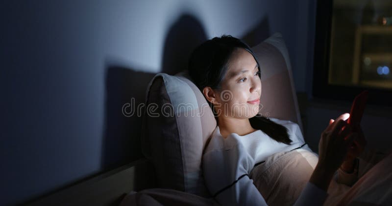 Woman Use of Mobile Phone on Bed Stock Image - Image of lying, asleep ...