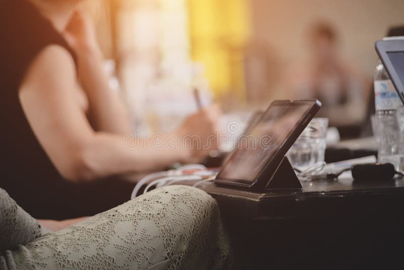 Woman Uses a Tablet at a Business Conference. the Tablet is on the ...
