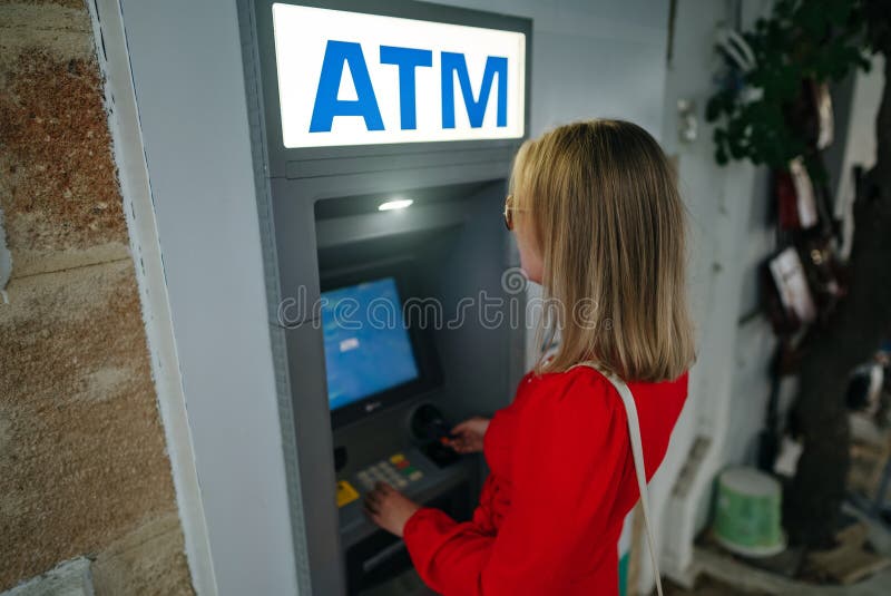 Woman using ATM stock photo. Image of withdraw, outdoors - 304117920