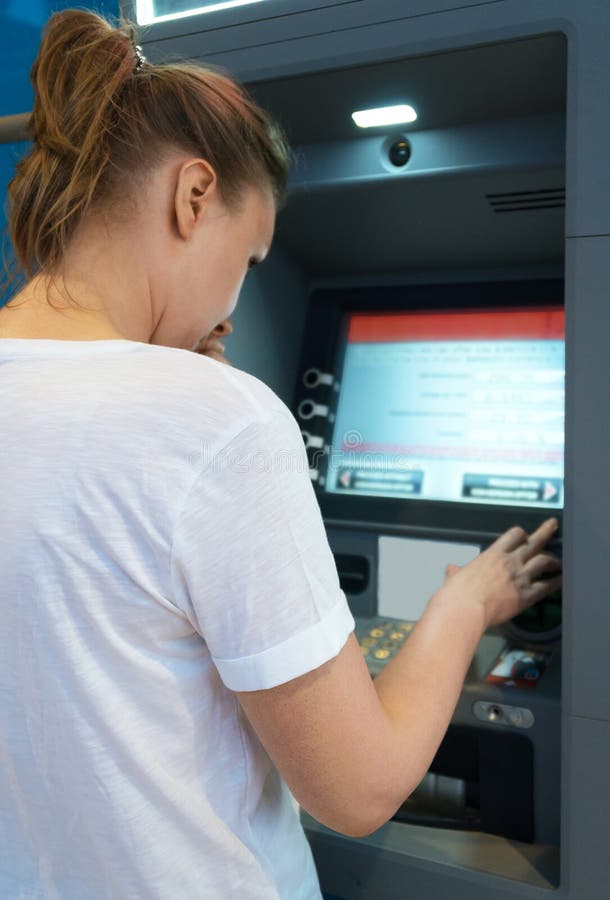 Pretty woman using ATM. stock image. Image of machine - 125238055