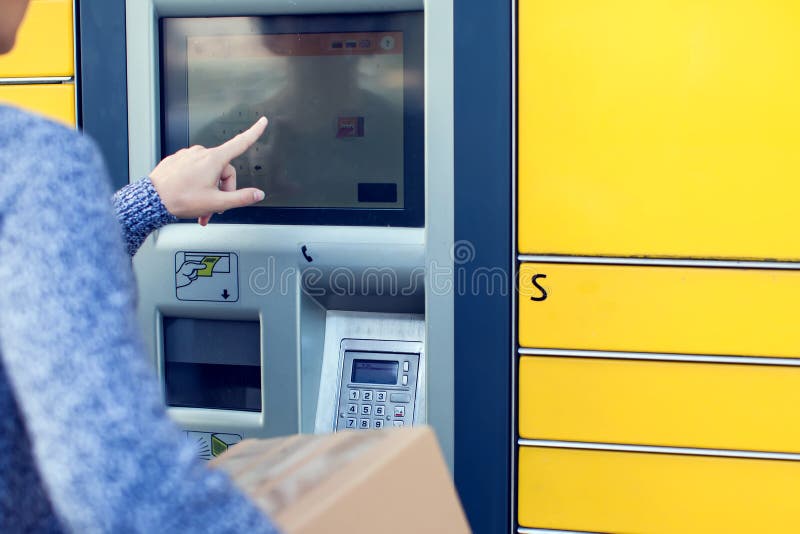 Woman Using Automated Self Service Post Terminal Machine or Lock Stock ...