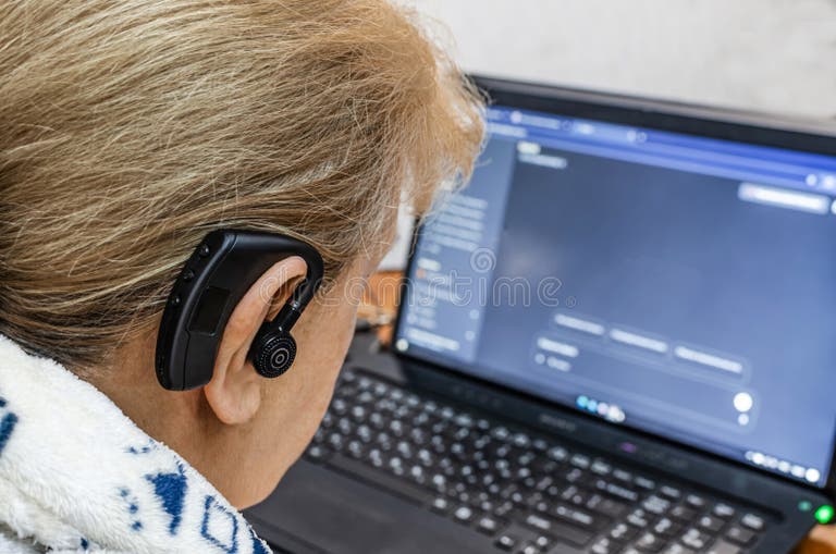 Woman Using Bluetooth Headset while Working on Laptop Stock Image ...