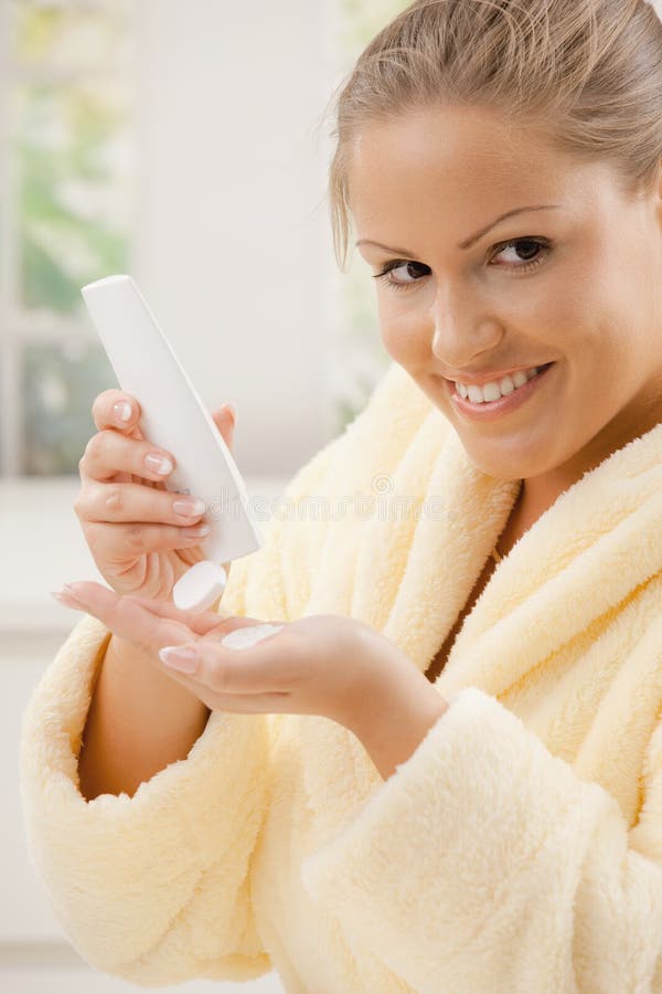 Woman using body lotion stock photo. Image of alone, clear - 18216084