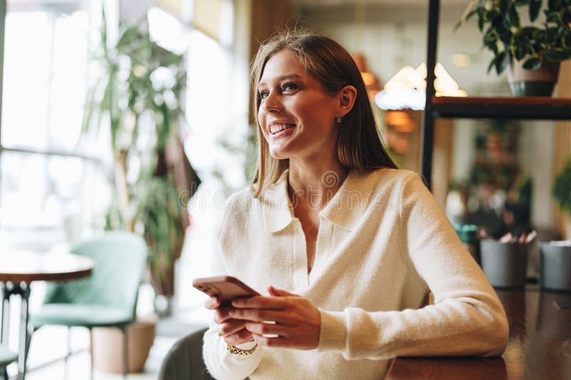 Woman Using Cell Phone at Table Stock Image - Image of indoors ...