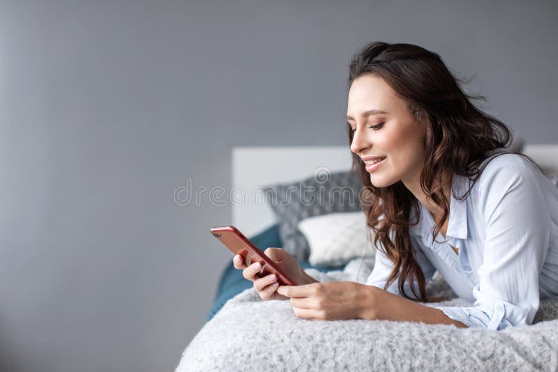 Woman Using Cellphone Bed at Home Stock Image - Image of indoors ...