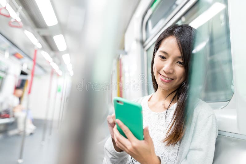 Woman Using Cellphone on Train Stock Image - Image of looking ...