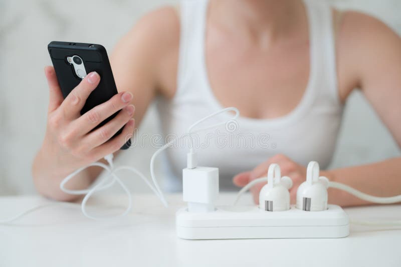 Woman Using and Charging a Smartphone. Energy for Life Stock Photo ...