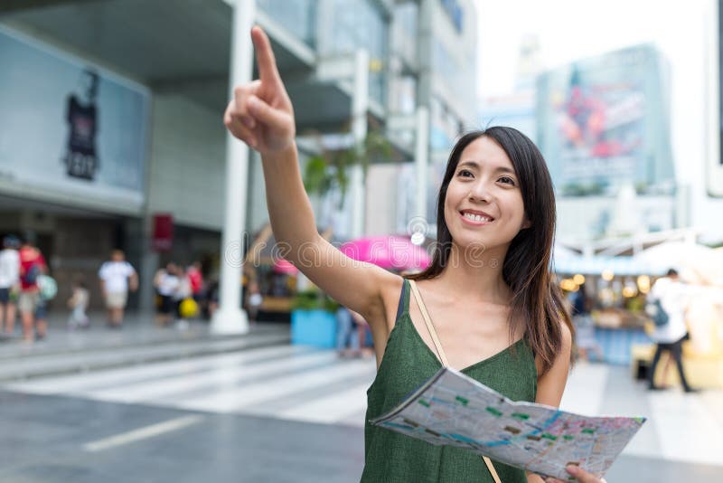 Woman Using City Map and Finger Pointing Far Away Stock Image - Image ...