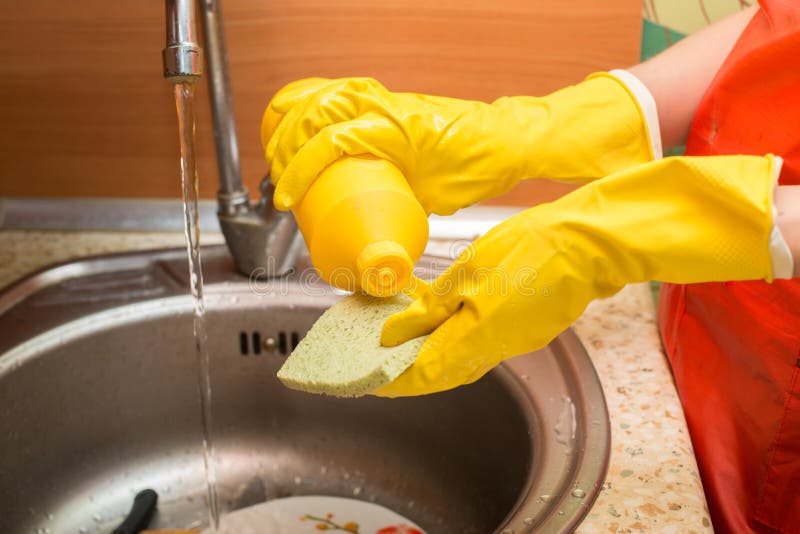 Woman Using Cleaning Product on Sponge Doing the Dishes at Home`s ...