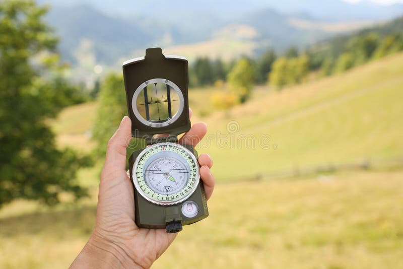 Woman Using Compass for Navigation during Journey in Mountains, Closeup ...