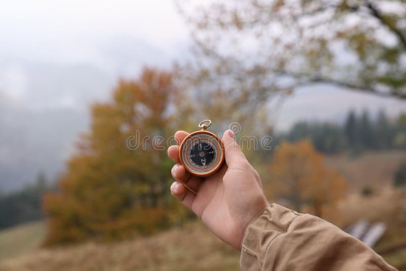 Woman Using Compass for Navigation during Journey in Mountains, Closeup ...