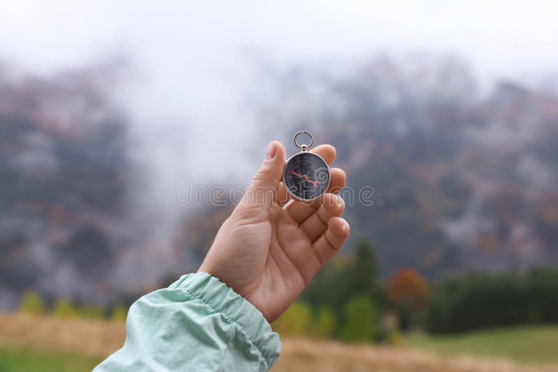 Woman Using Compass for Navigation during Journey in Mountains, Closeup ...