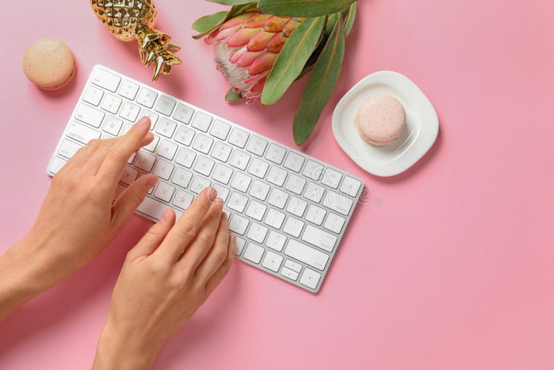 Woman Using Computer Keyboard on Table Decorated with Tropical Flower ...
