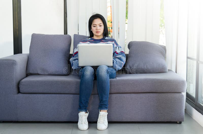 Woman Using Computer Laptop on Sofa in Her House. Stock Image - Image ...