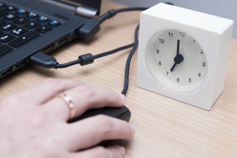 Woman Using Computer Mouse with Laptop and White Clock on the Table ...