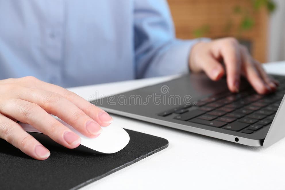Woman Using Computer Mouse while Working with Laptop at White Table ...
