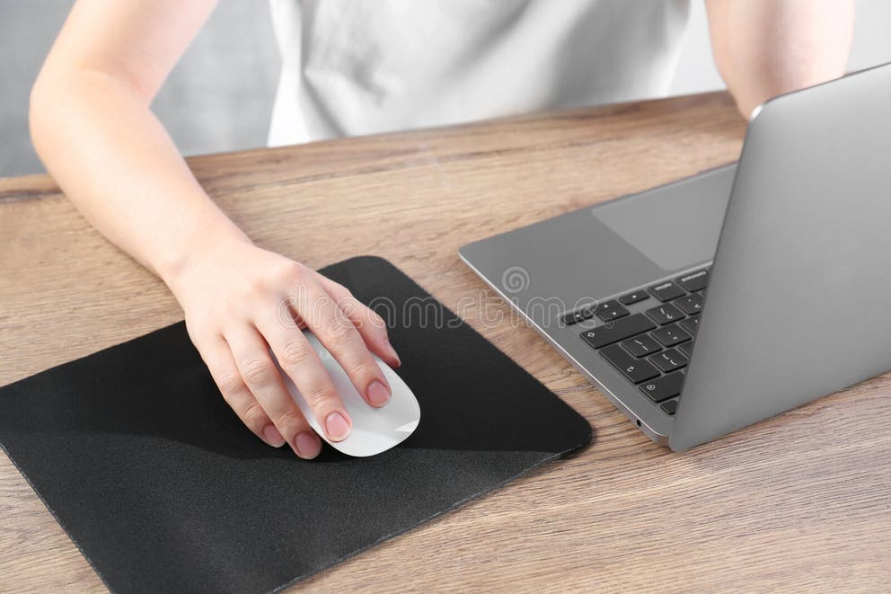Woman Using Computer Mouse while Working with Laptop at Wooden Table ...