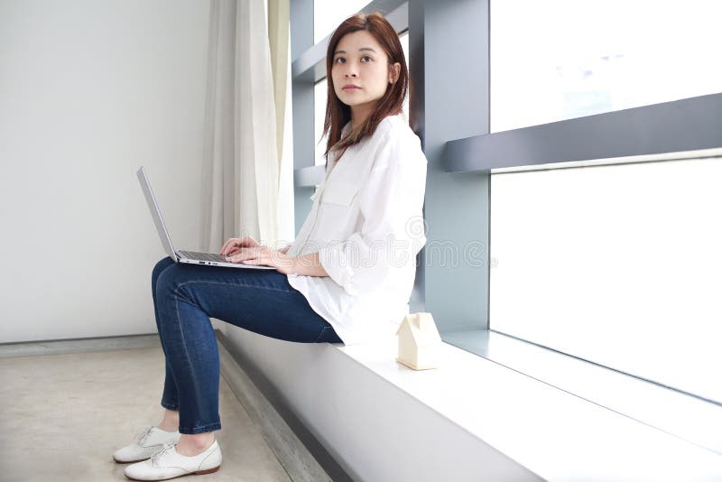 Woman Using the Computer Near the Window Stock Photo - Image of ...