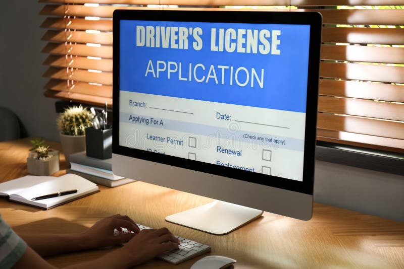 Woman Using Computer To Fill Driver`s License Application Form at Table ...