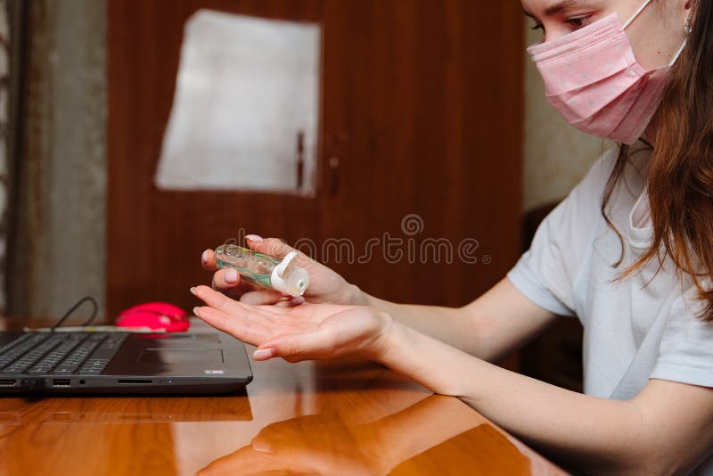 Woman Using Computer Wearing Mask and Applying Antiseptic.Precautions ...