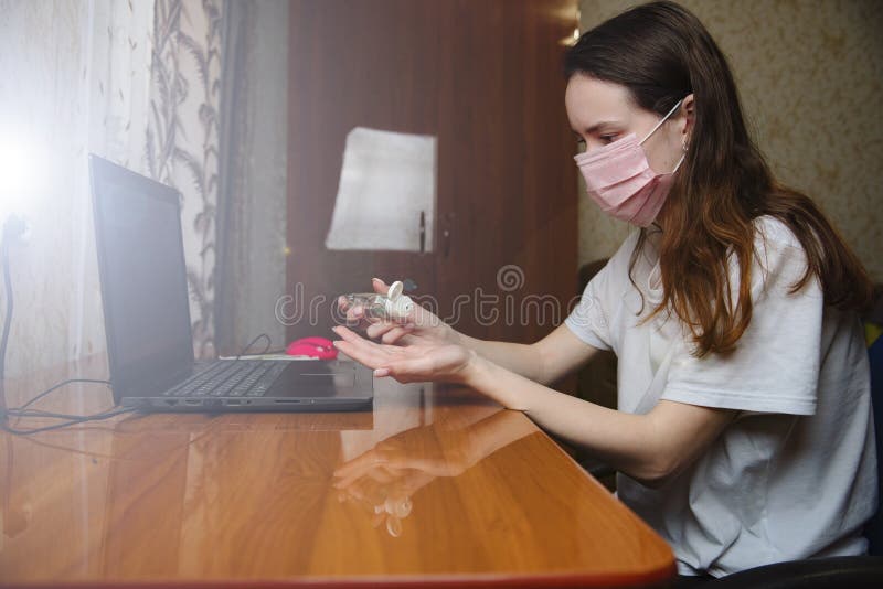 Woman Using Computer Wearing Mask and Applying Antiseptic.Precautions ...