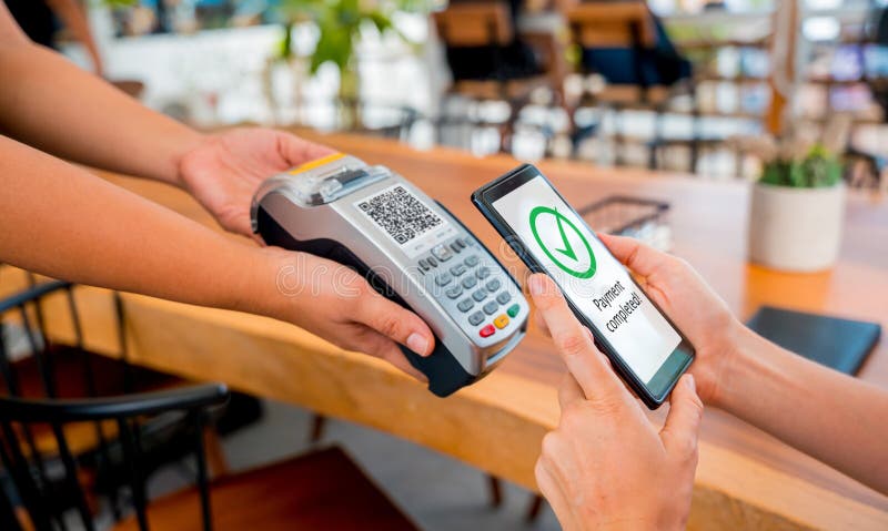 Woman Using Contactless Payment by Mobile Phone with QR Code at Cafe ...