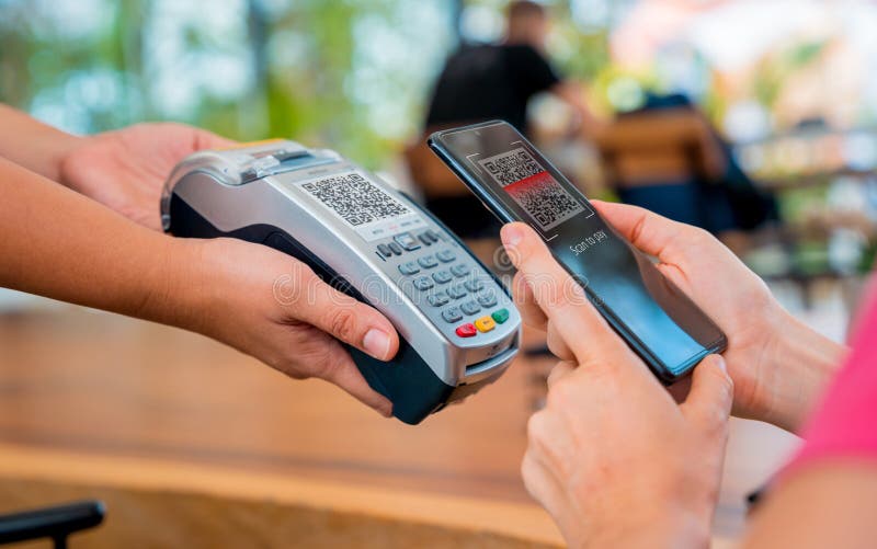 Woman Using Contactless Payment by Mobile Phone with QR Code at Cafe ...