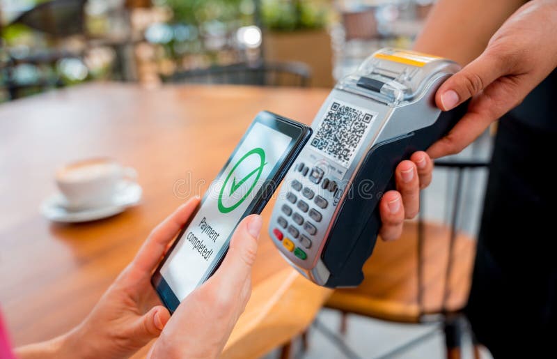 Woman Using Contactless Payment by Mobile Phone with QR Code at Cafe ...