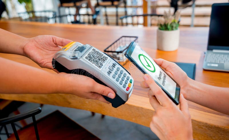 Woman Using Contactless Payment by Mobile Phone with QR Code at Cafe ...