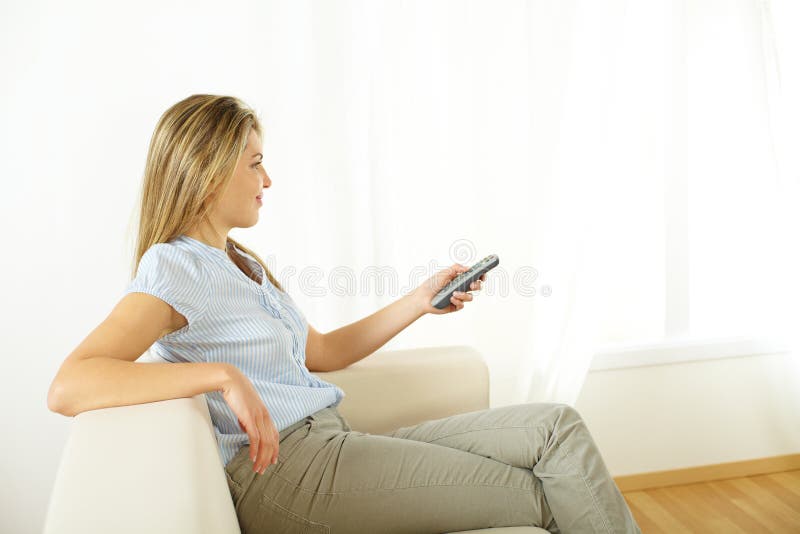 Woman Using a Control Remote Stock Image - Image of comfortable ...