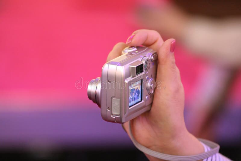 Woman using digital camera stock photo. Image of metal - 562722