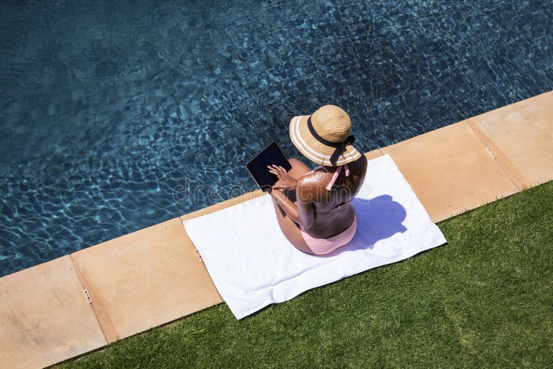 Woman Using Digital Tablet while Sitting by the Pool Stock Image ...