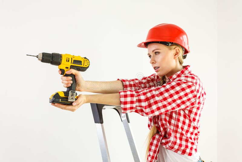 Woman Using Drill on Ladder Stock Image - Image of tool, industry ...