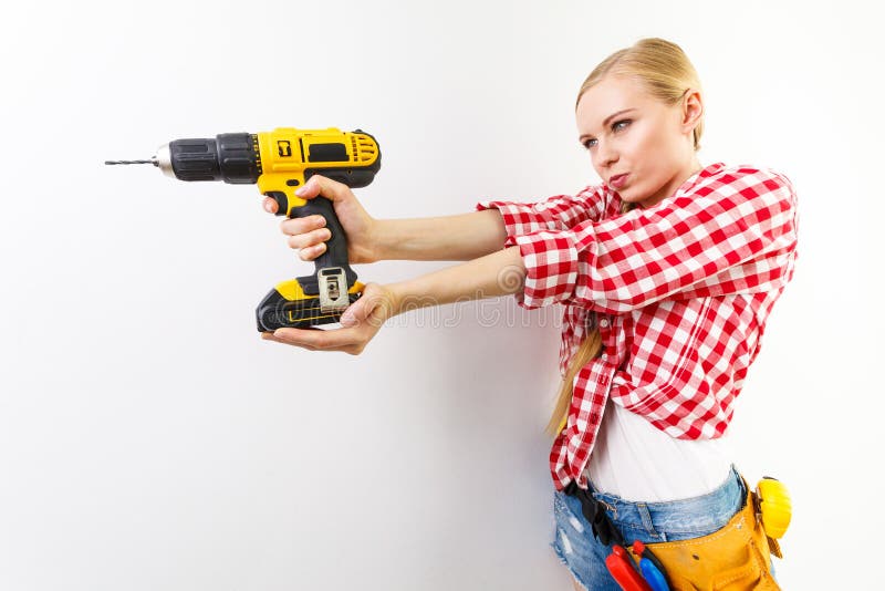Woman using drill on wall stock image. Image of working - 122539477