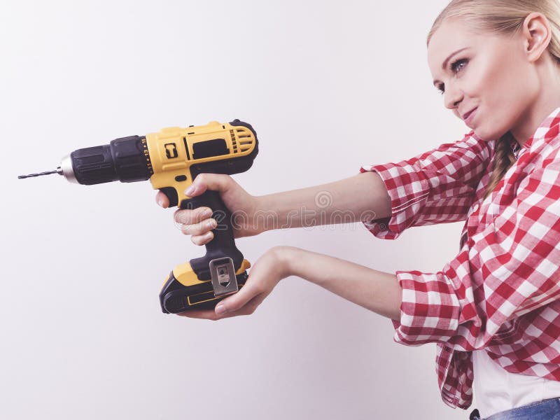 Woman using drill on wall stock image. Image of drilling - 172253703
