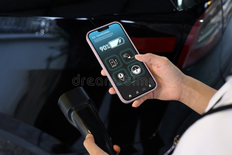 Woman Using EV Application on Smartphone To Check Charging Status while ...