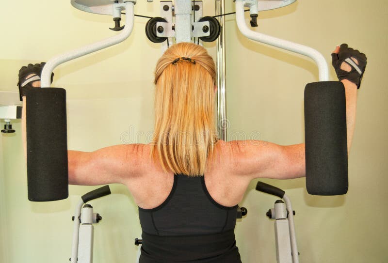 Woman Using Exercise Machine Stock Image - Image of machine, exercise ...