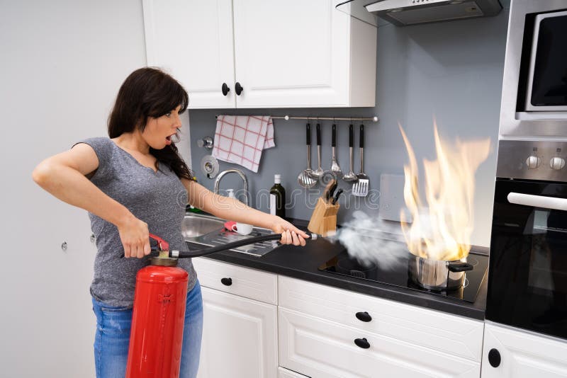Woman Using Fire Extinguisher To Stop Fire Stock Image - Image of girl ...