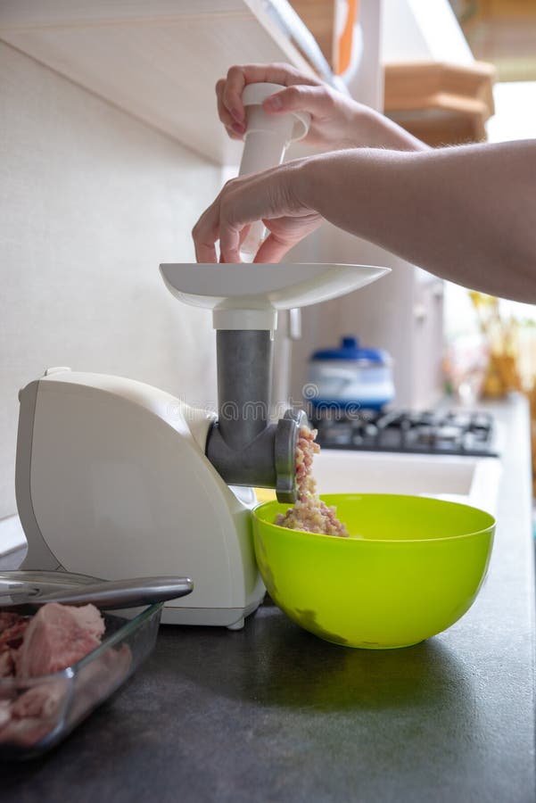 Woman Using Grinder for Preparation of Minced Meat in Kitchen Stock ...