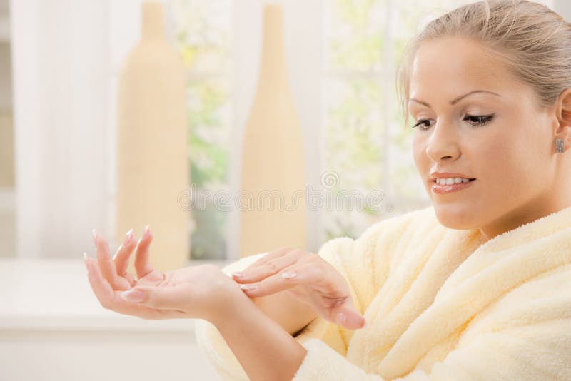 Woman using hand cream stock image. Image of adult, creamy - 11412887