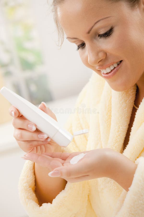 Woman using hand cream stock photo. Image of body, bathroom - 11604586