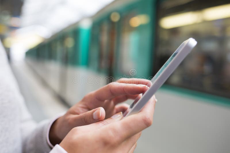 Woman Using Her Cell Phone on Subway Platform Stock Photo - Image of ...