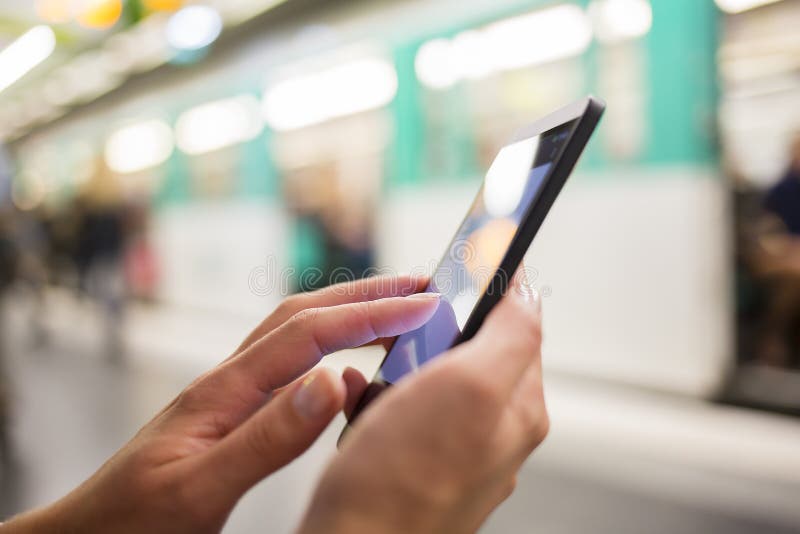 Woman Using Her Cell Phone on Subway Platform Stock Photo - Image of ...