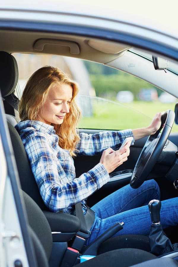 Woman Using Her Smartphone while Driving a Car Stock Photo - Image of ...