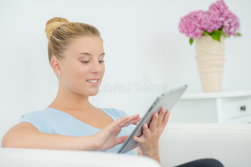 Woman Using Tablet Computer As she Waits for Appointment Stock Photo ...