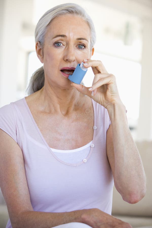 Woman Using an Inhaler stock image. Image of asthma, inside - 7771959