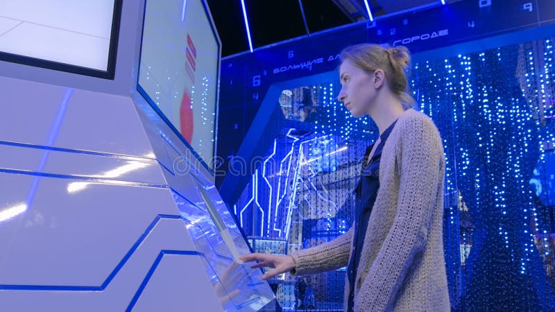 Man Using Interactive Touchscreen Display at Modern Museum or ...